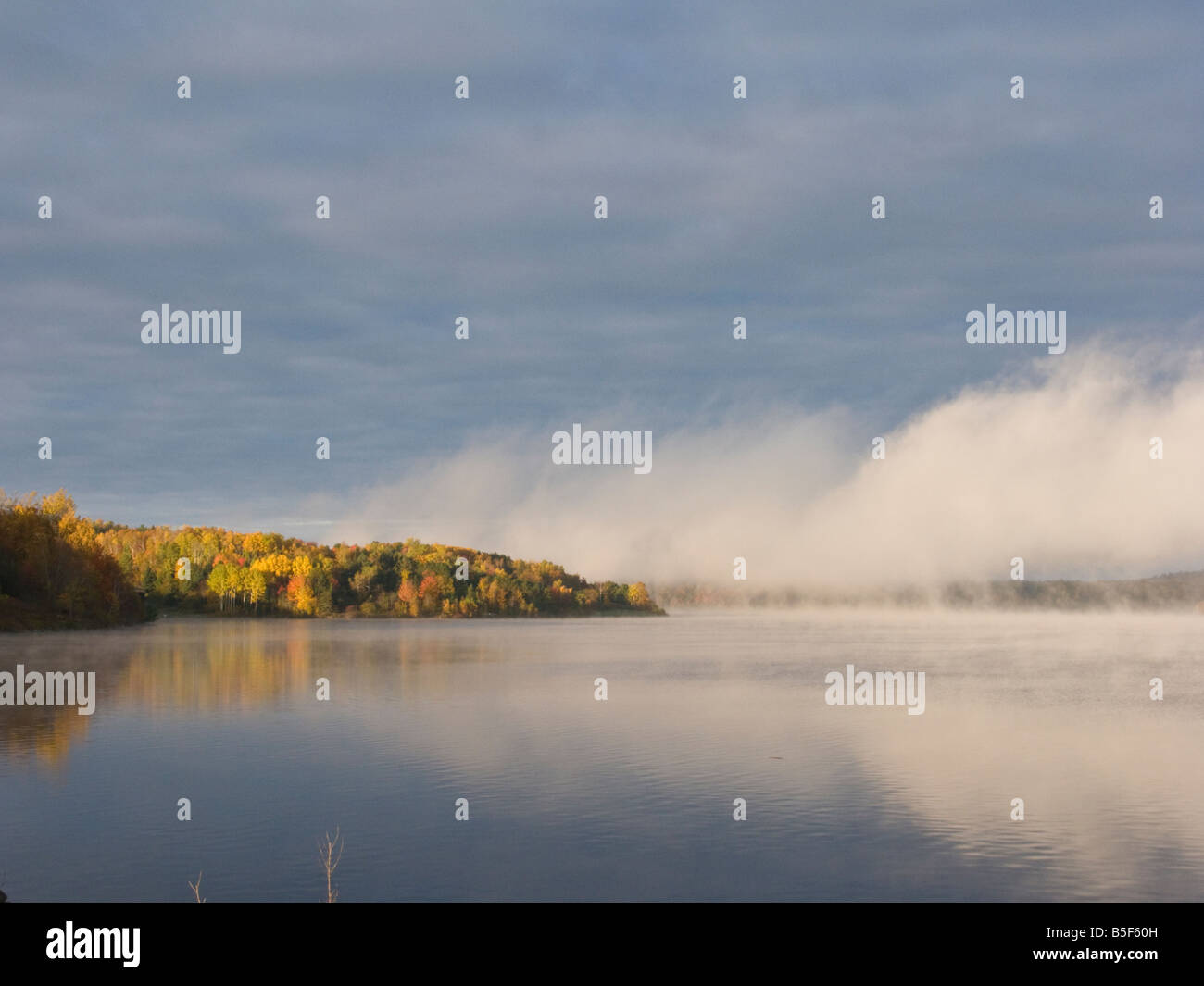 Heavy morning fog along the St John River during the fall with fall ...