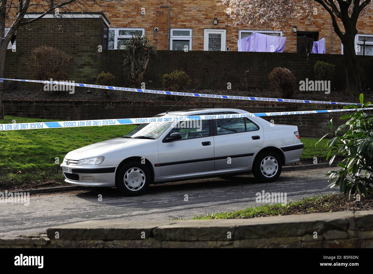 Police guard the flat in Lidgate Gardens in Dewsbury West Yorks where ...