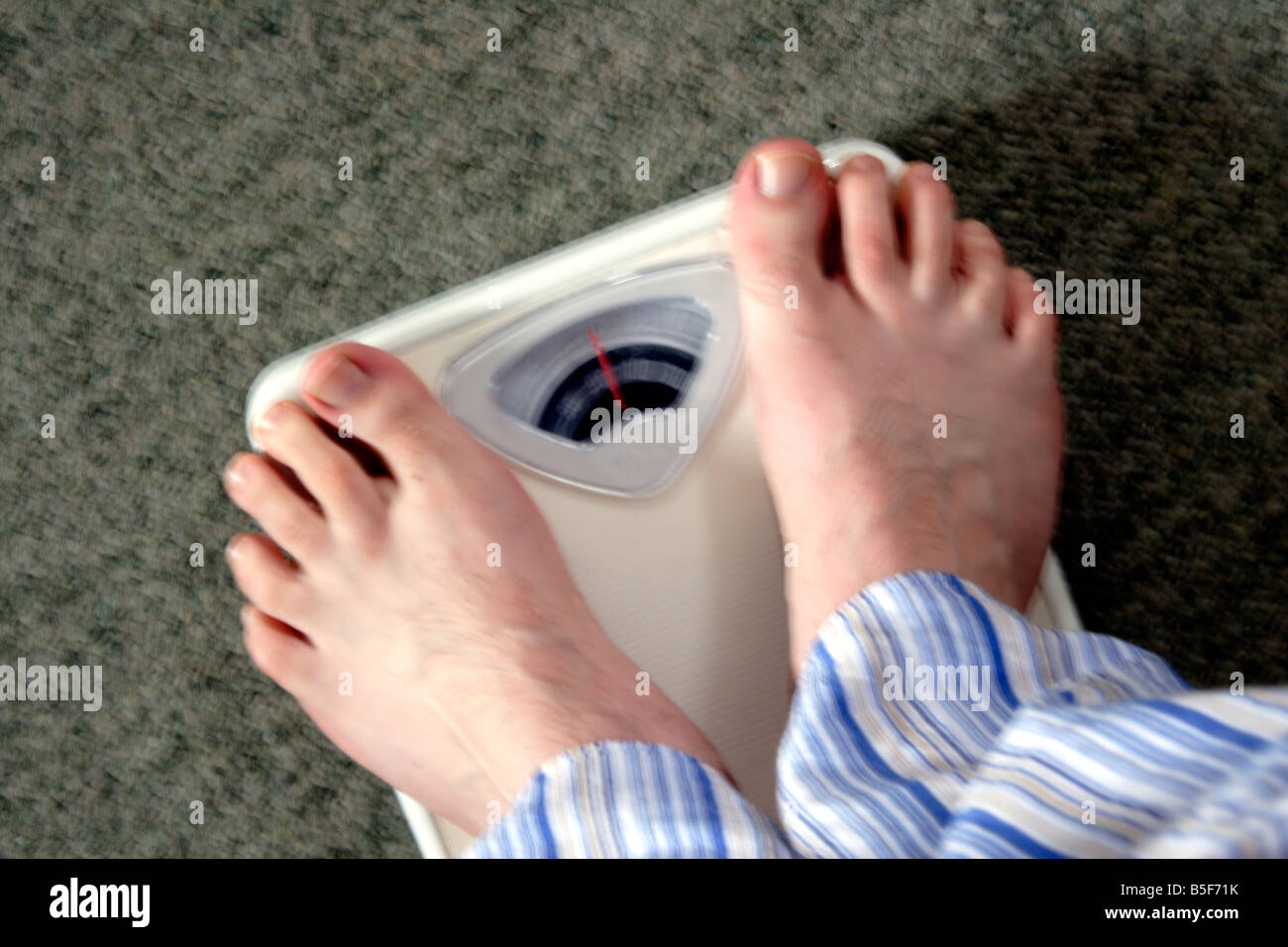 Person weighing themselves on scales close up Stock Photo - Alamy