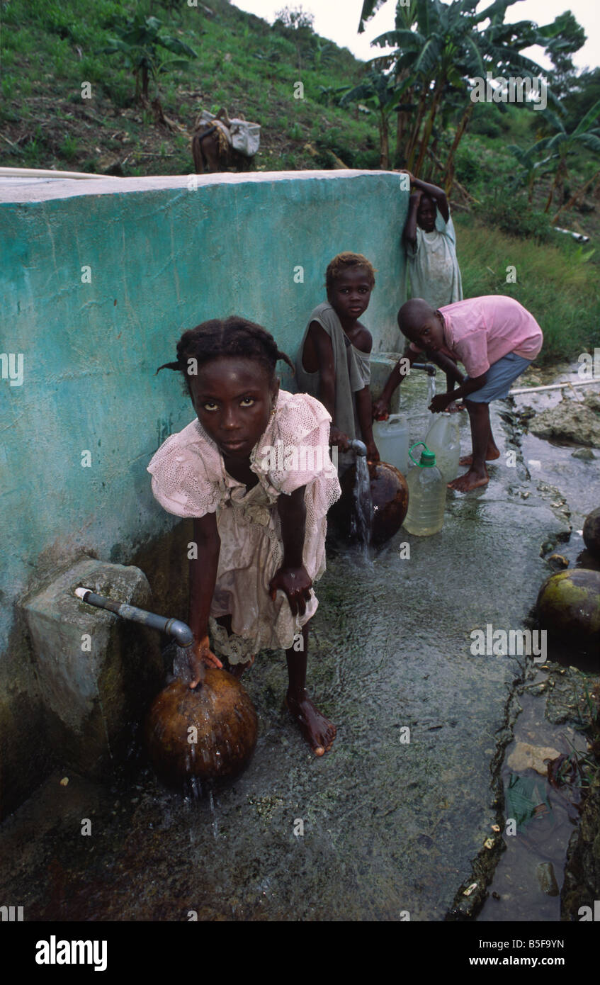 Young children collecting clean drinking water from a NGO funded water ...