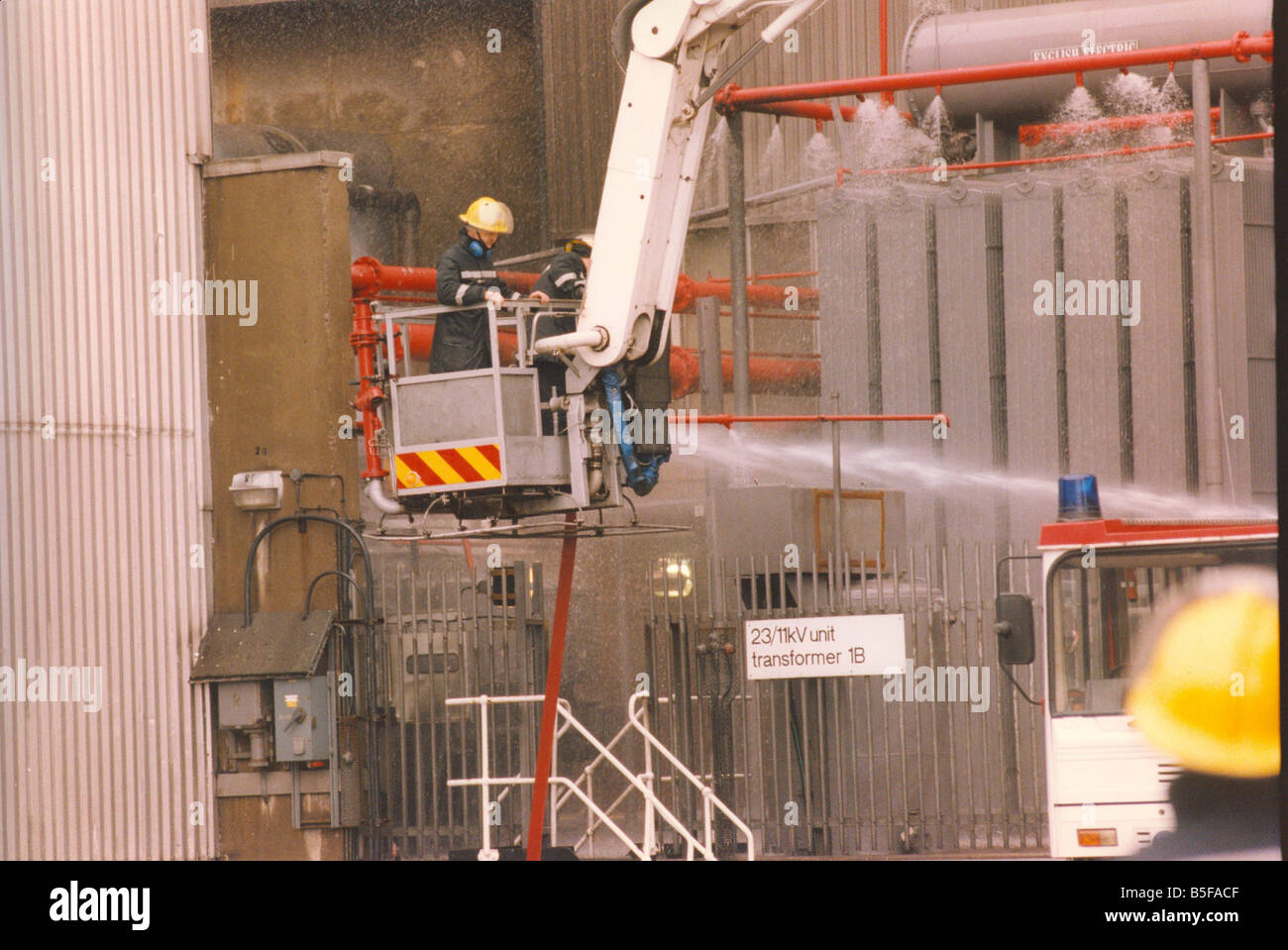 Firefighters get the warehouse fire under control Stock Photo - Alamy