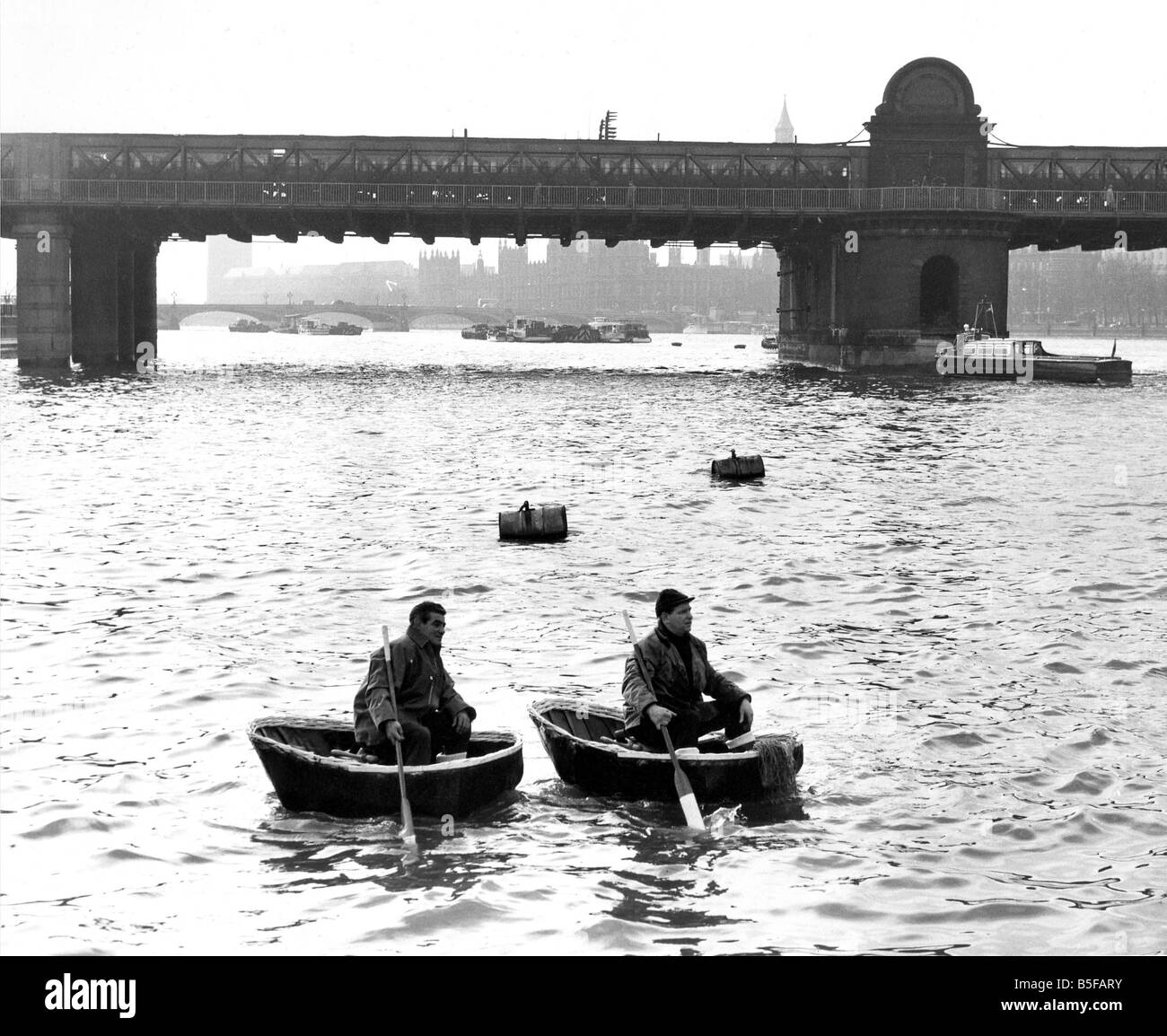 Coracles being paddled for the first time on the River Thames by the ...