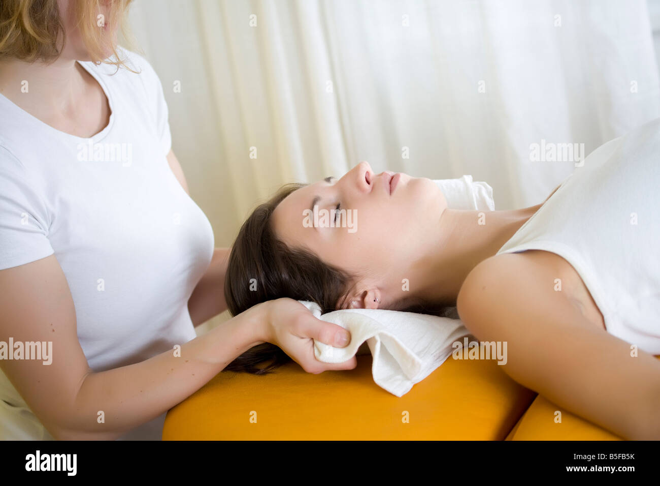 physio therapy: therapist relaxes tensions of neck muscles Stock Photo ...