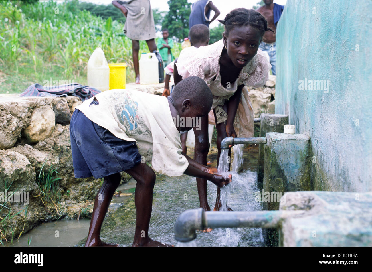Young children collecting clean drinking water from a NGO funded water ...