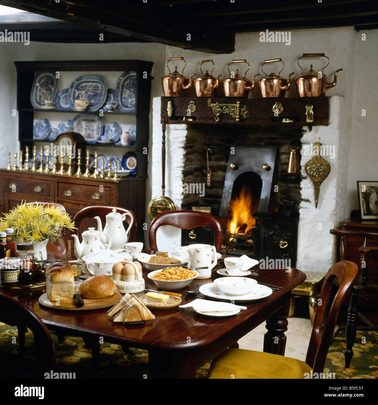 Table set for tea with white crockery in cottage dining room with ...