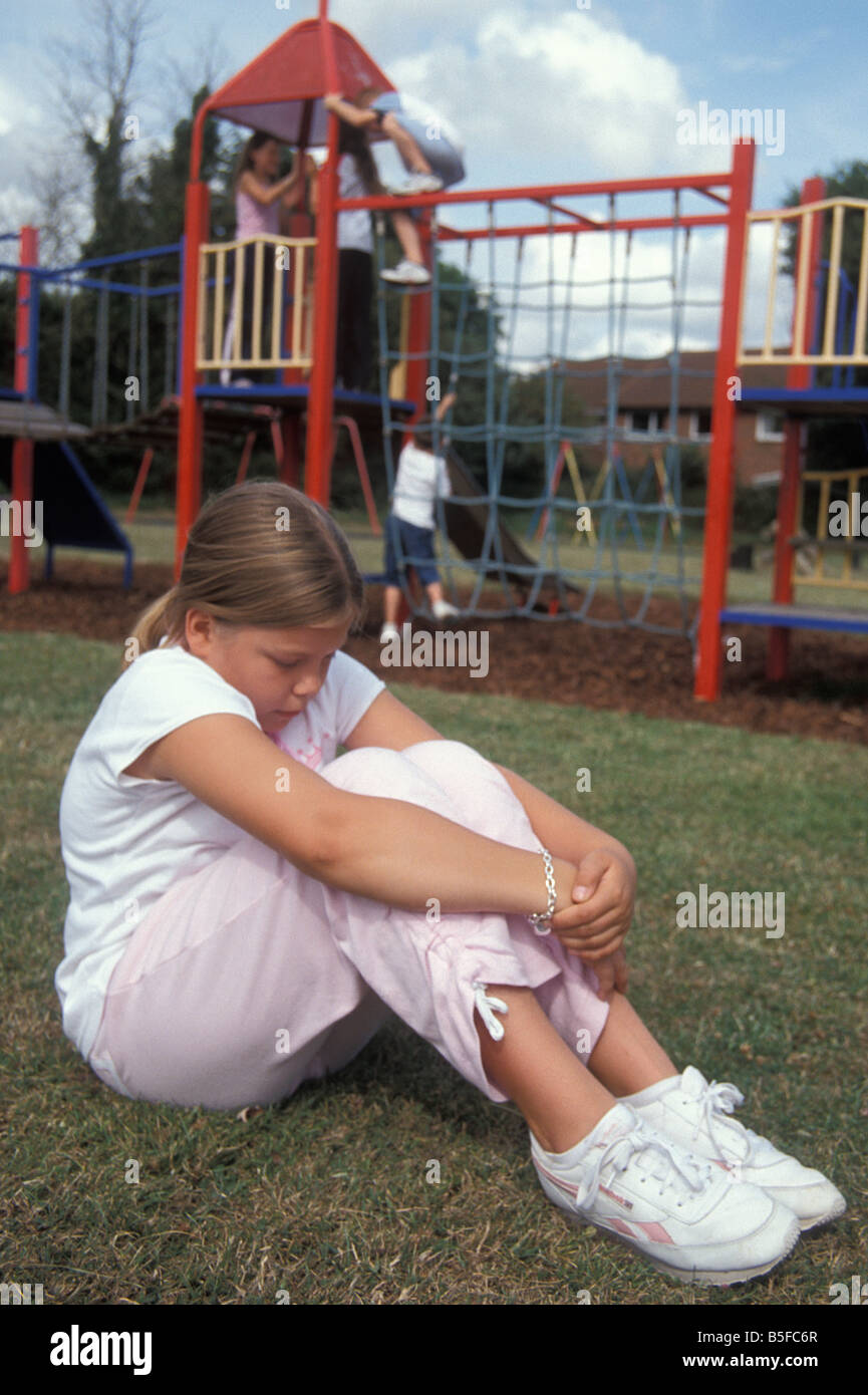 young girl in playground feeling left out Stock Photo - Alamy
