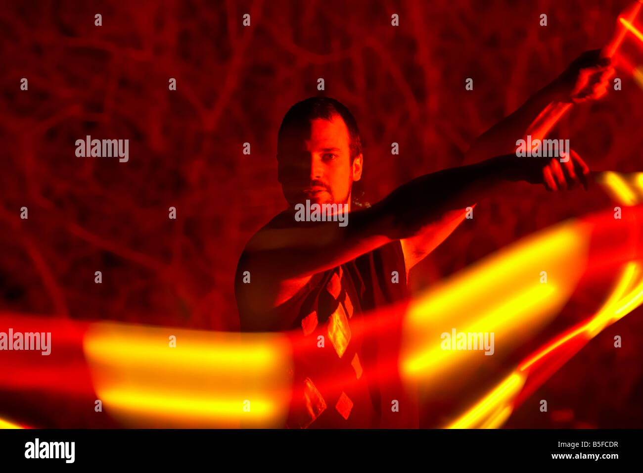 man juggling LED juggling clubs playing with lights Stock Photo - Alamy