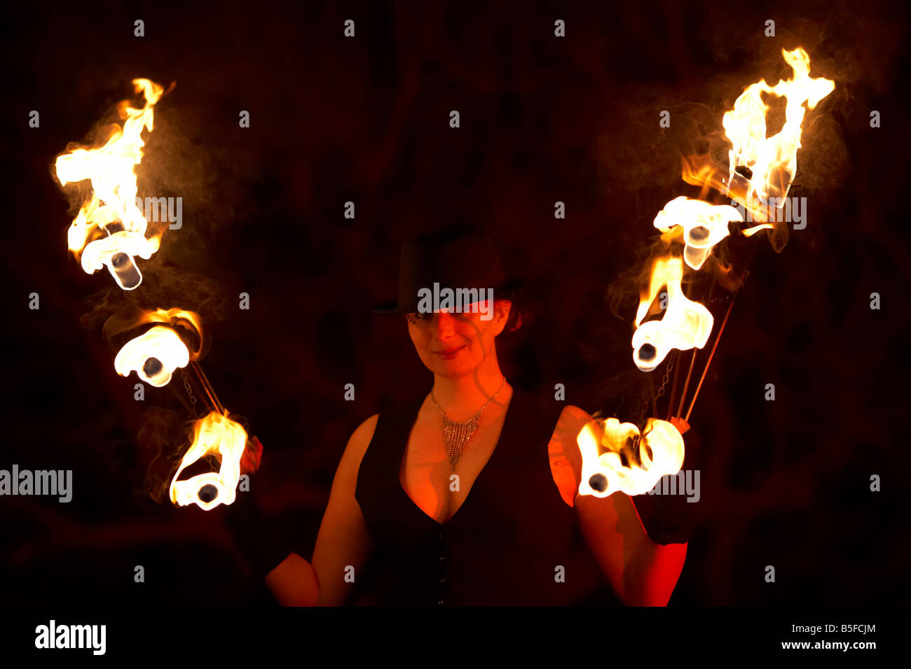 firepoise female fire dance performance artist wearing hat holding fire ...