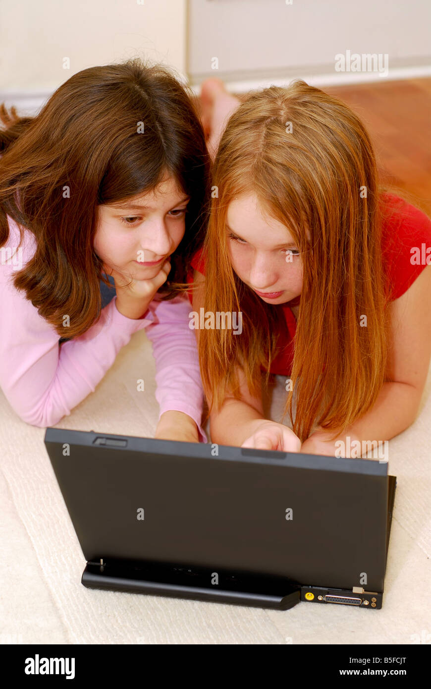 Two girls lie on the carpet hi-res stock photography and images - Alamy