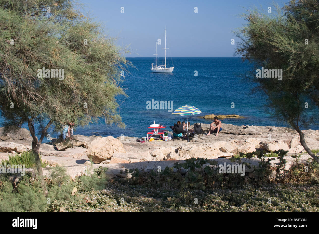 Family relaxing on the beach, Marsaskala, Malta Stock Photo - Alamy