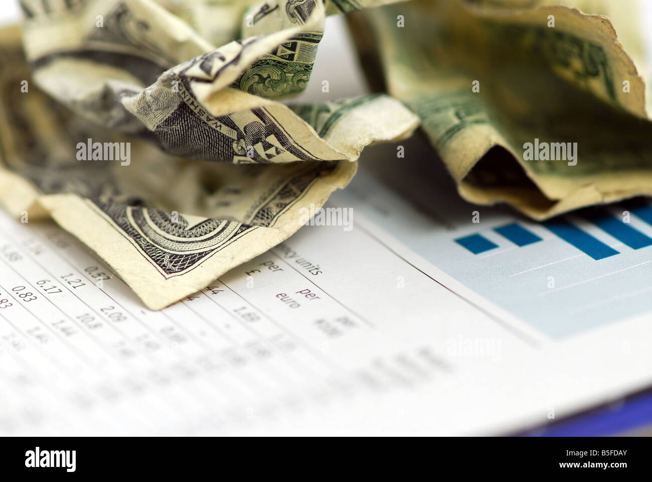 Crumpled us dollars on financial chart Stock Photo - Alamy