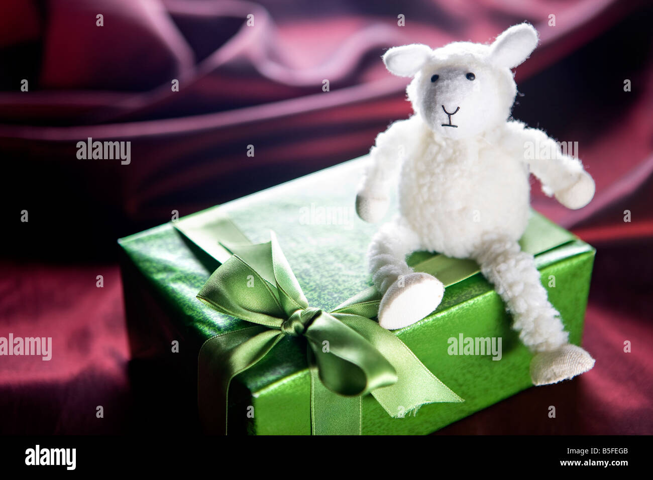 White toy sheep sitting on a gift box Stock Photo - Alamy