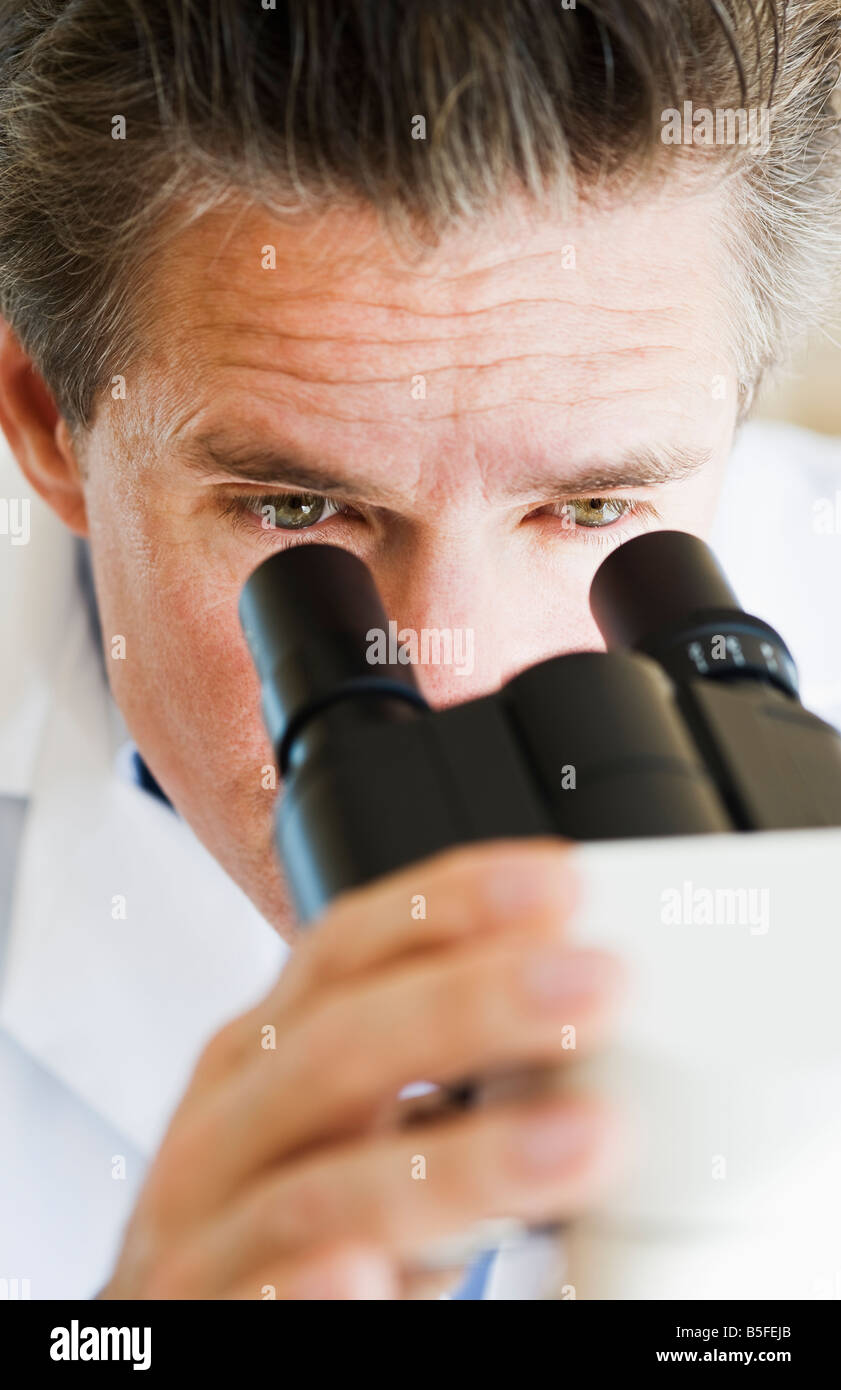 scientist looking through microscope Stock Photo - Alamy