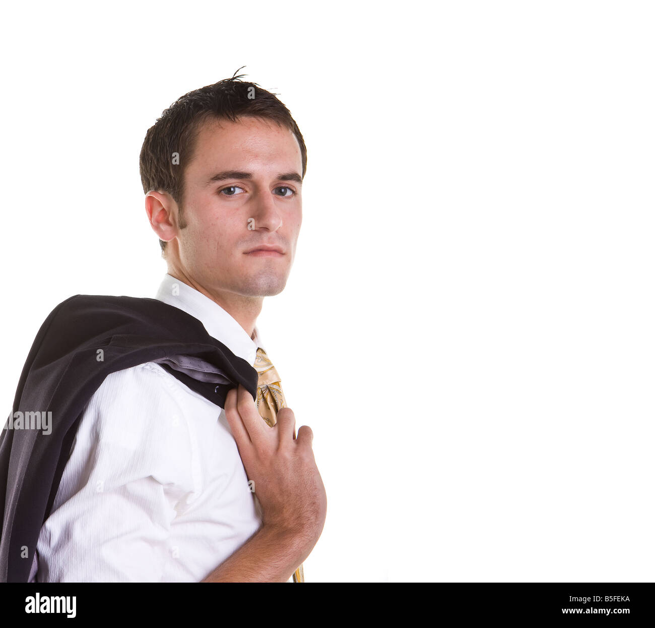 A young businessman with a serious look and his jacket thrown over his ...