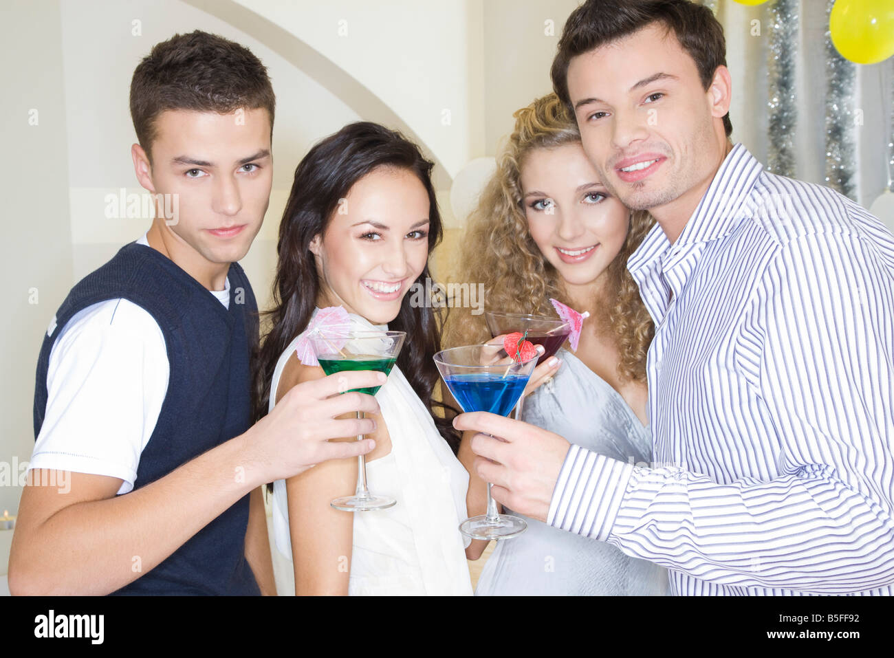 friends drinking cocktails at party Stock Photo - Alamy
