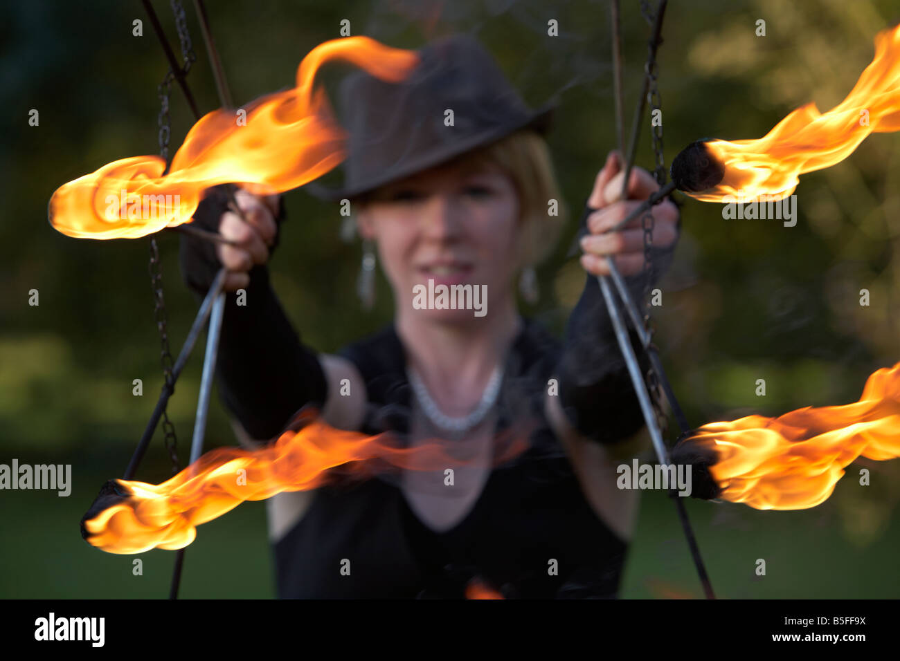 firepoise female fire dance performance artist wearing hat holding fire ...