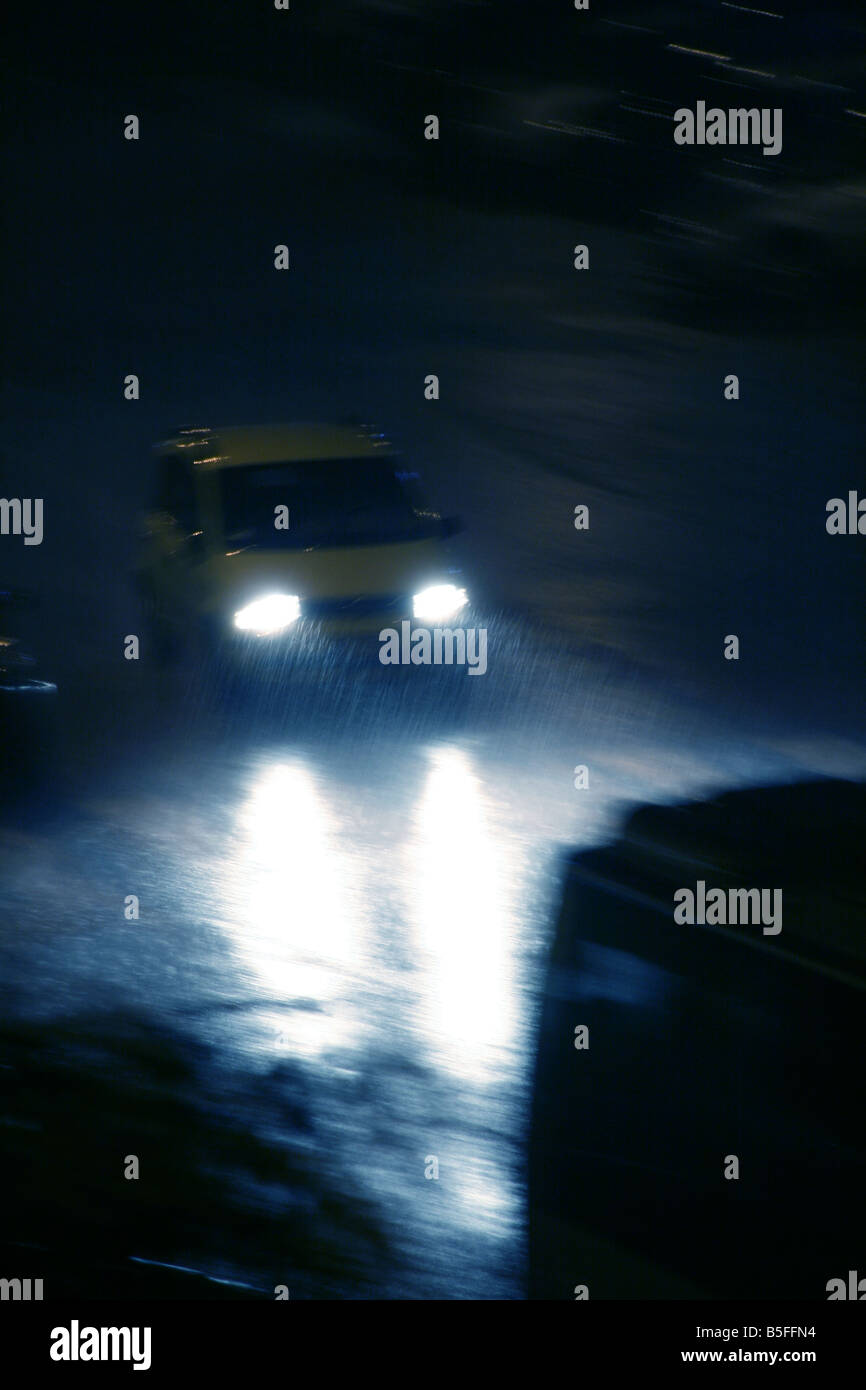 fast car driving in heavy rain at night in town Stock Photo - Alamy