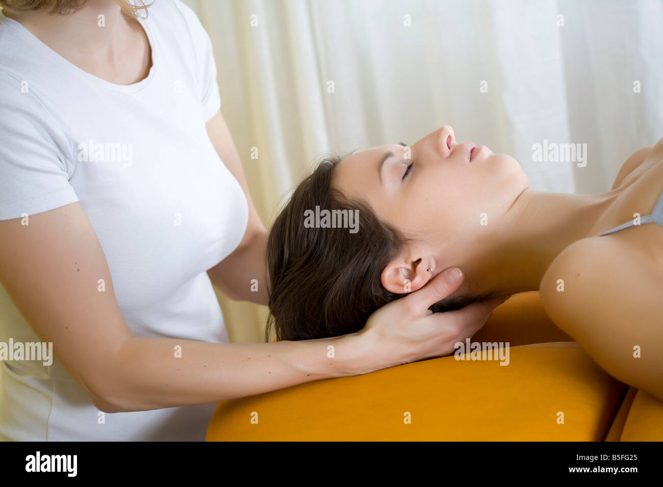 physio therapy: therapist relaxes tensions of neck muscles Stock Photo ...