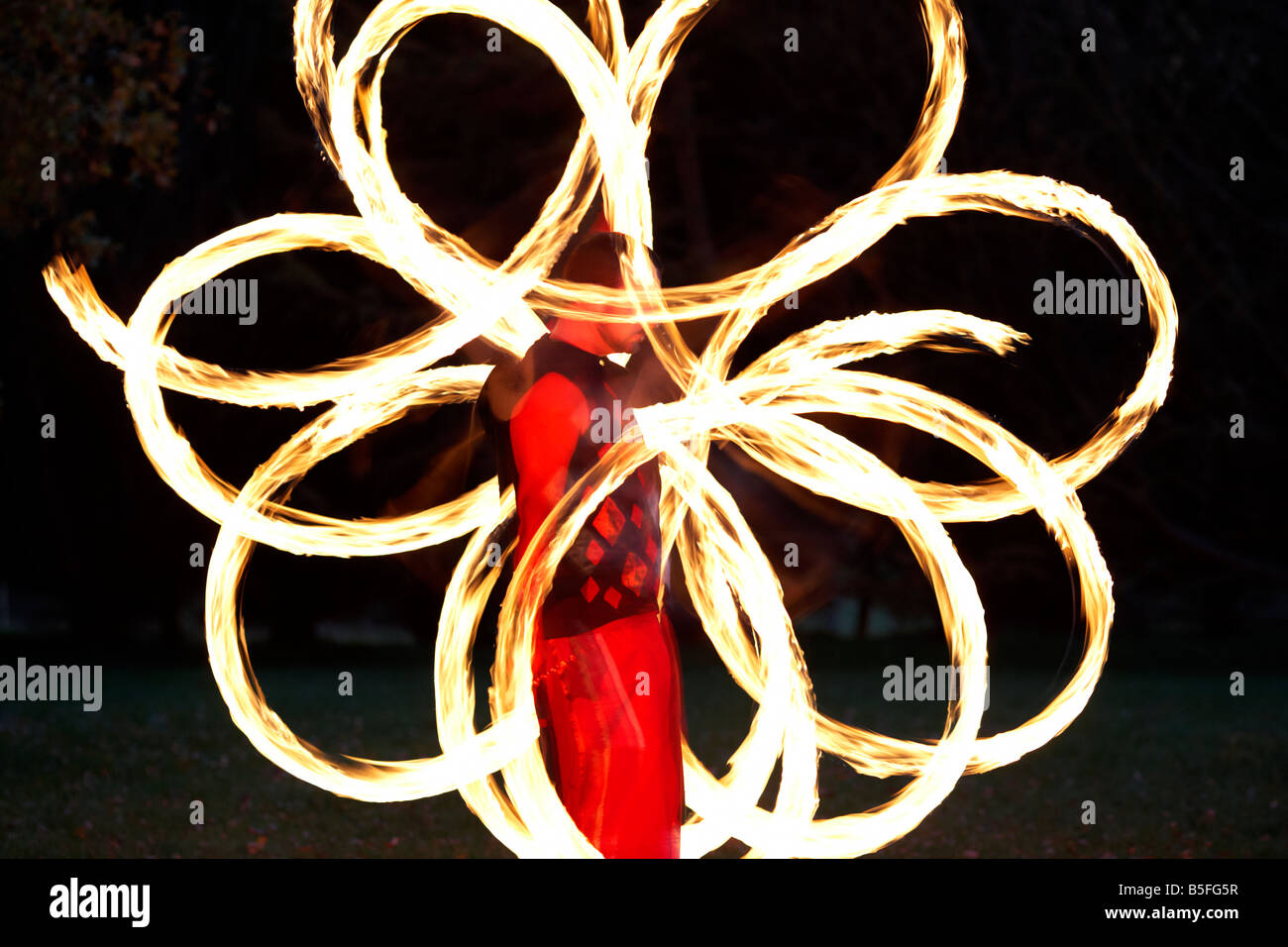 firepoise man performance artist displaying fire patterns with poi ...