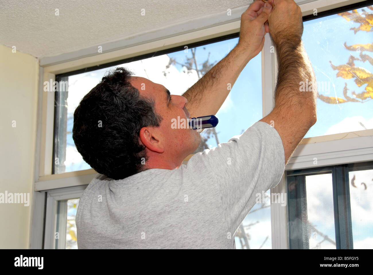 Man installing window blinds in a house Stock Photo - Alamy