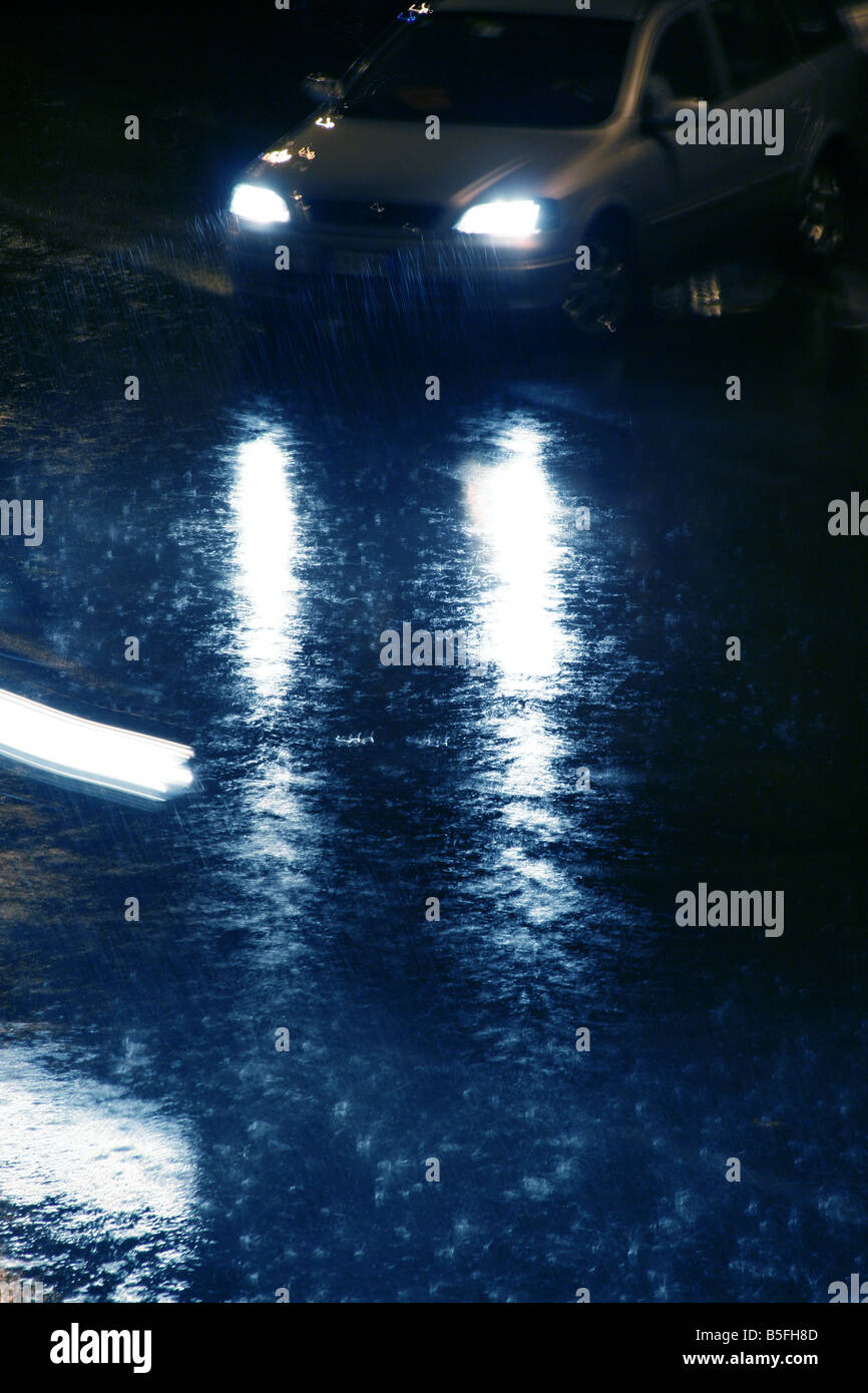 fast car driving in heavy rain at night in town Stock Photo - Alamy