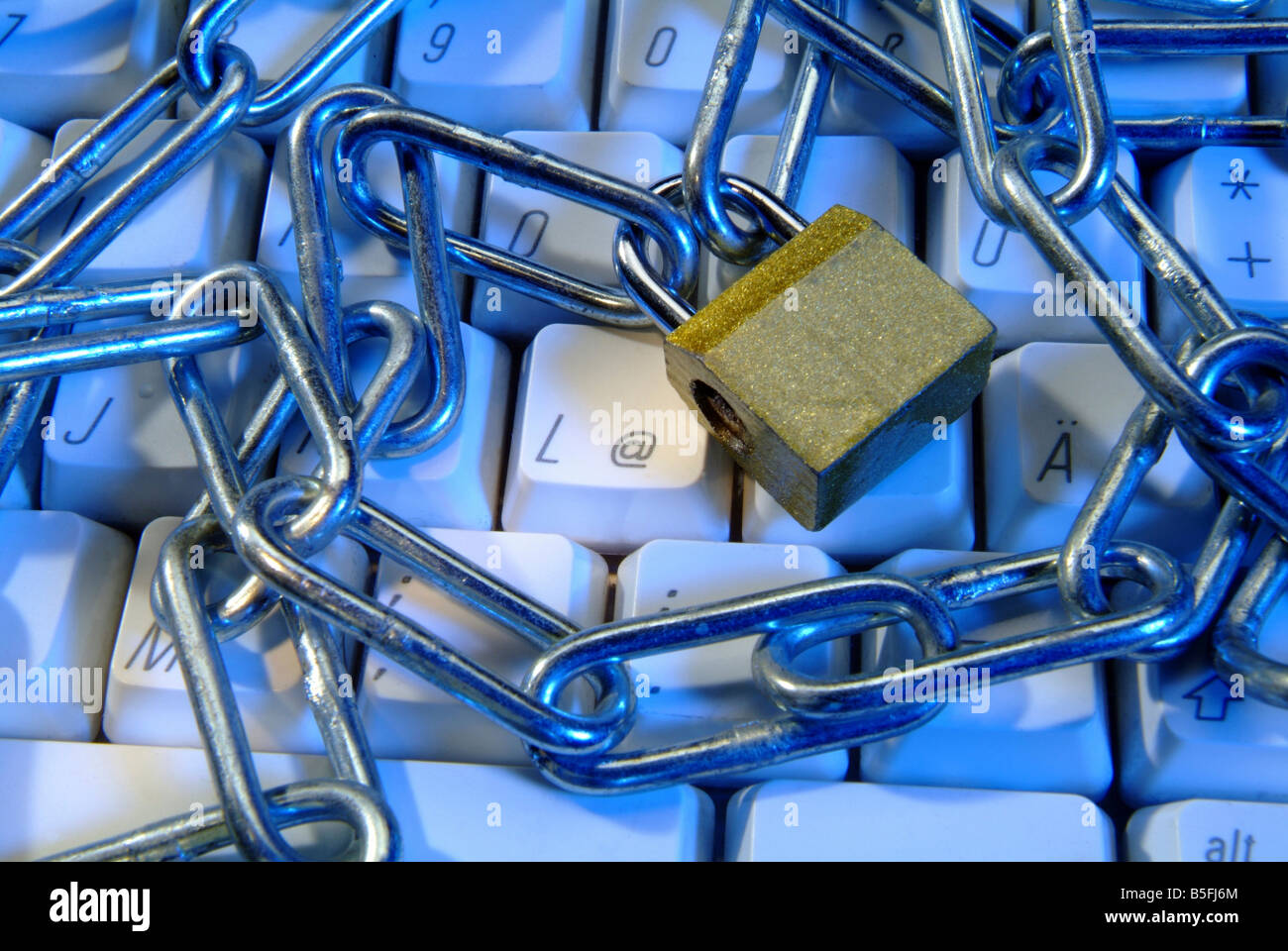 Chain around a computer keyboard with @ sign Stock Photo - Alamy