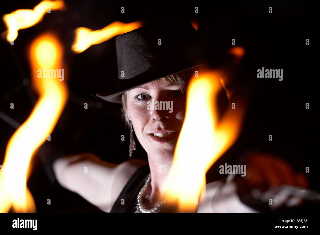 firepoise female fire dance performance artist wearing hat holding fire ...