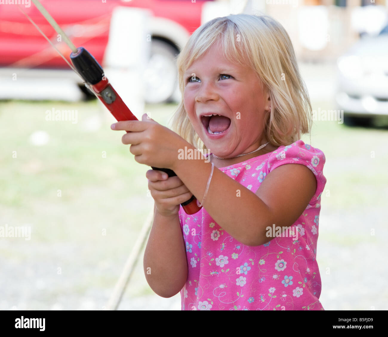 Little girl happy about catching a fish Stock Photo - Alamy
