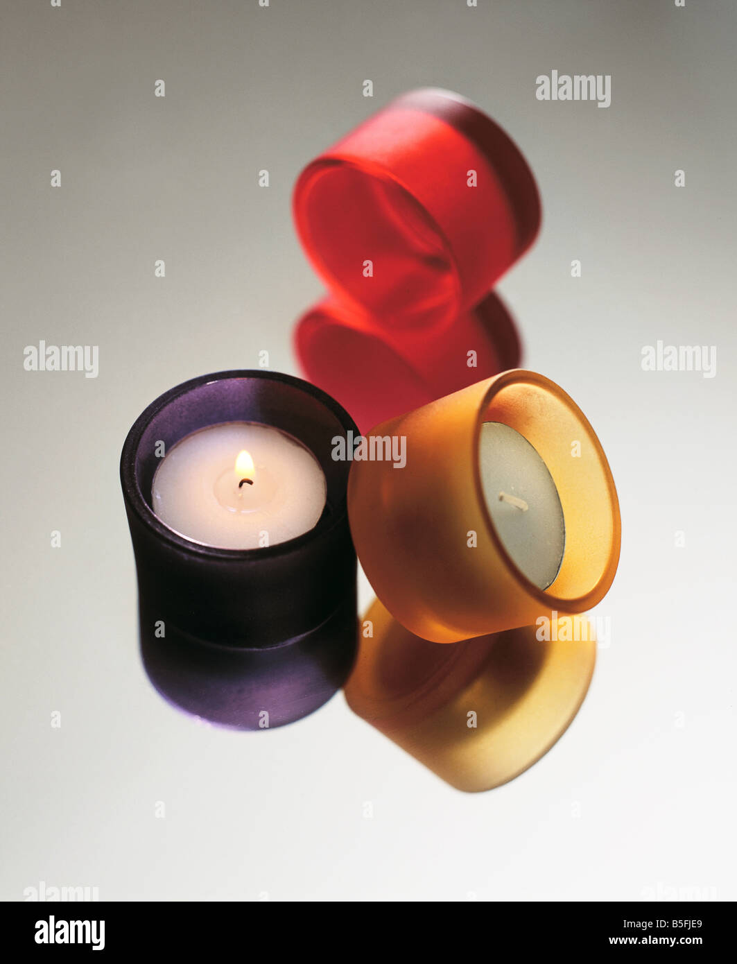three candles photographed on a mirror like surface Stock Photo - Alamy