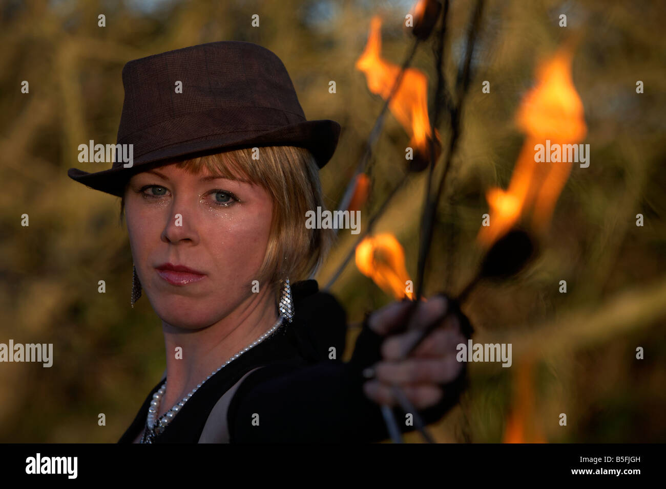 firepoise female fire dance performance artist wearing hat holding fire ...