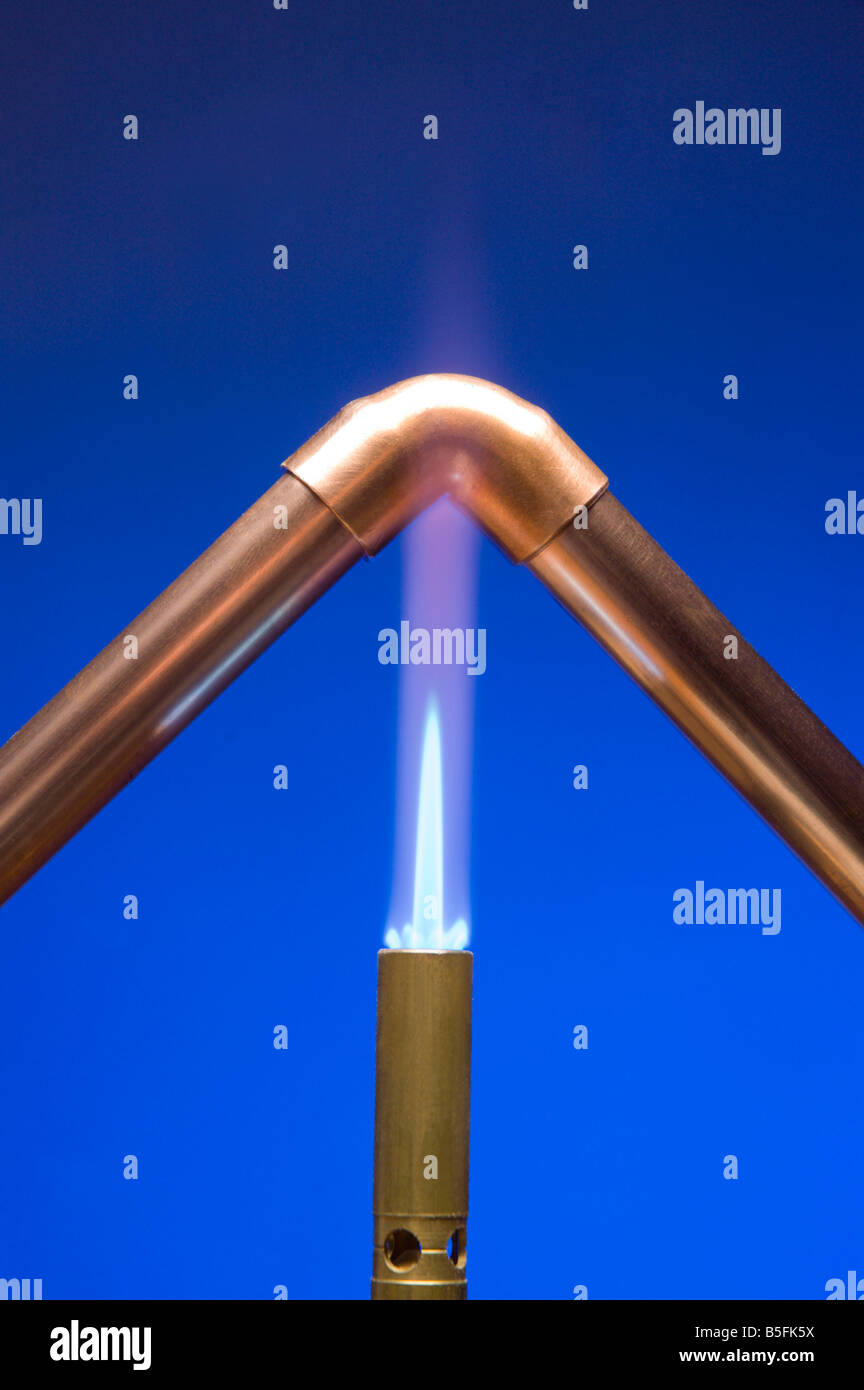 Copper elbow join heated up for soldering Stock Photo - Alamy