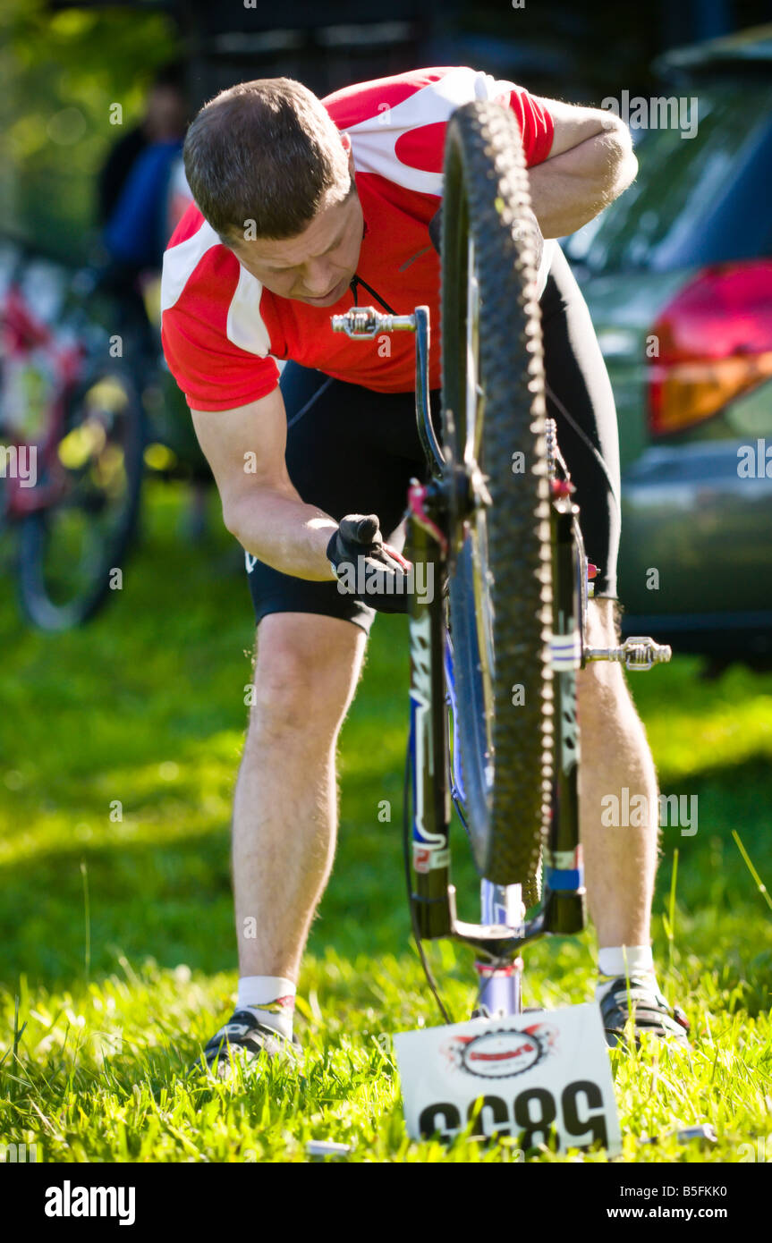 A male working on his bicycle before the start of a race Stock Photo ...