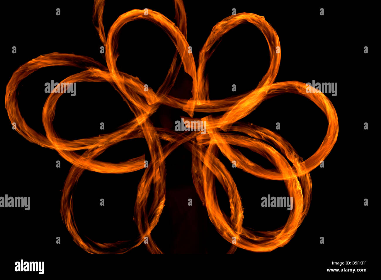 firepoise man performance artist displaying fire patterns with poi ...