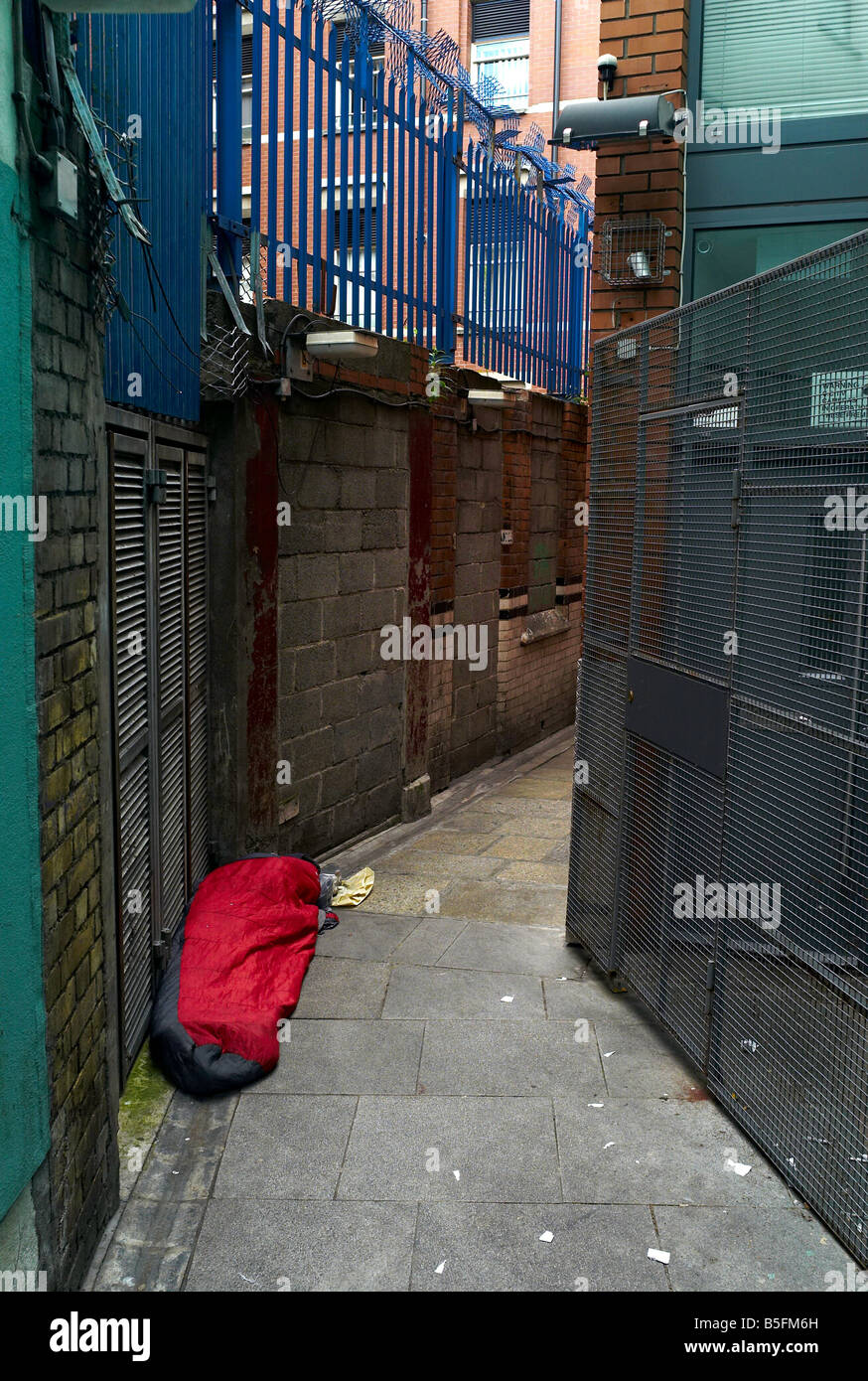 Homeless person asleep in a sleeping bag up an alleyway in Dublin ...