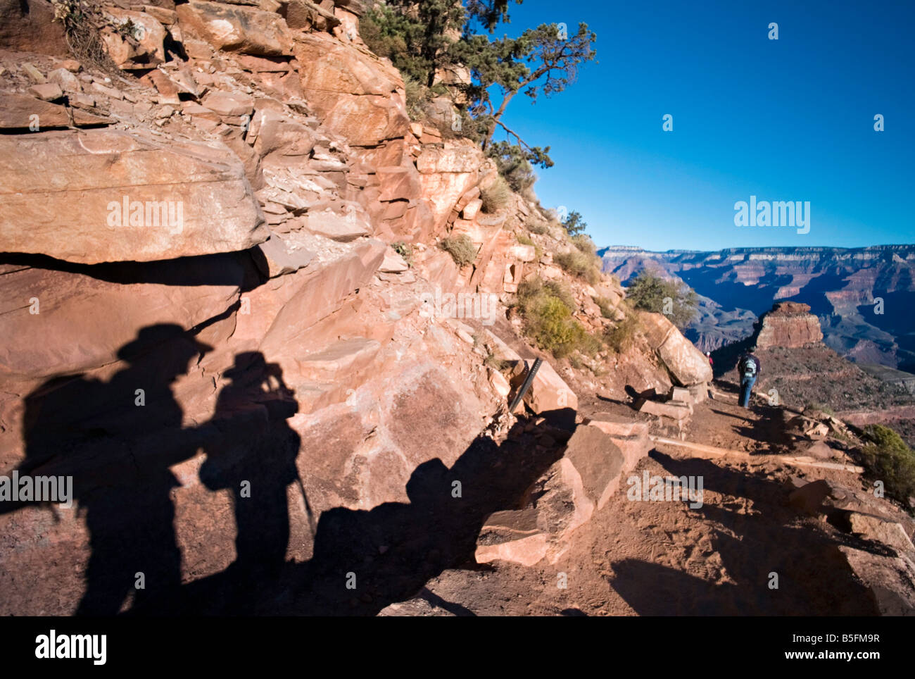 ARIZONA GRAND CANYON Shadows of hikers pausing to take a photo on the ...