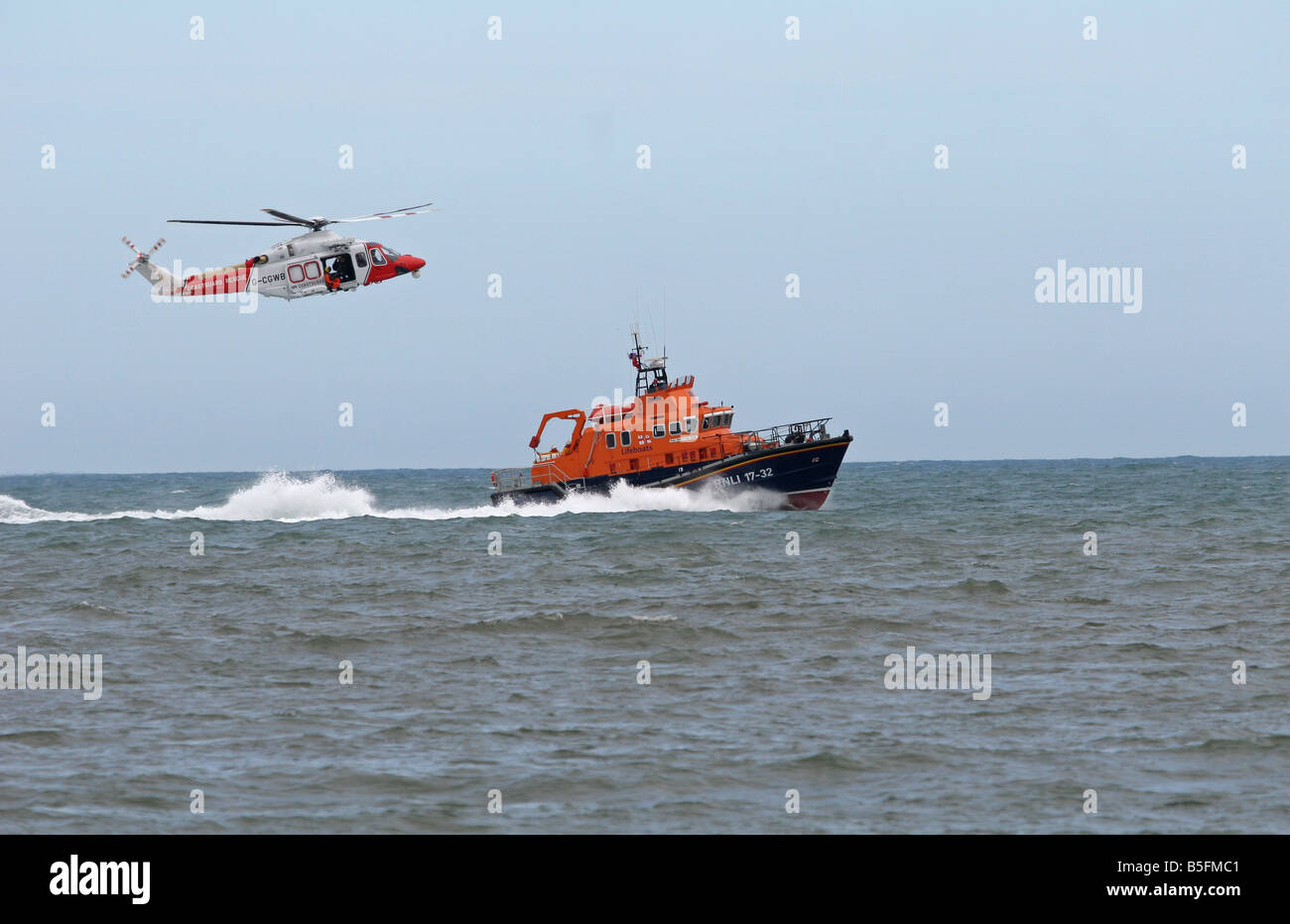 coast guard helicopter over lifeboat Stock Photo - Alamy