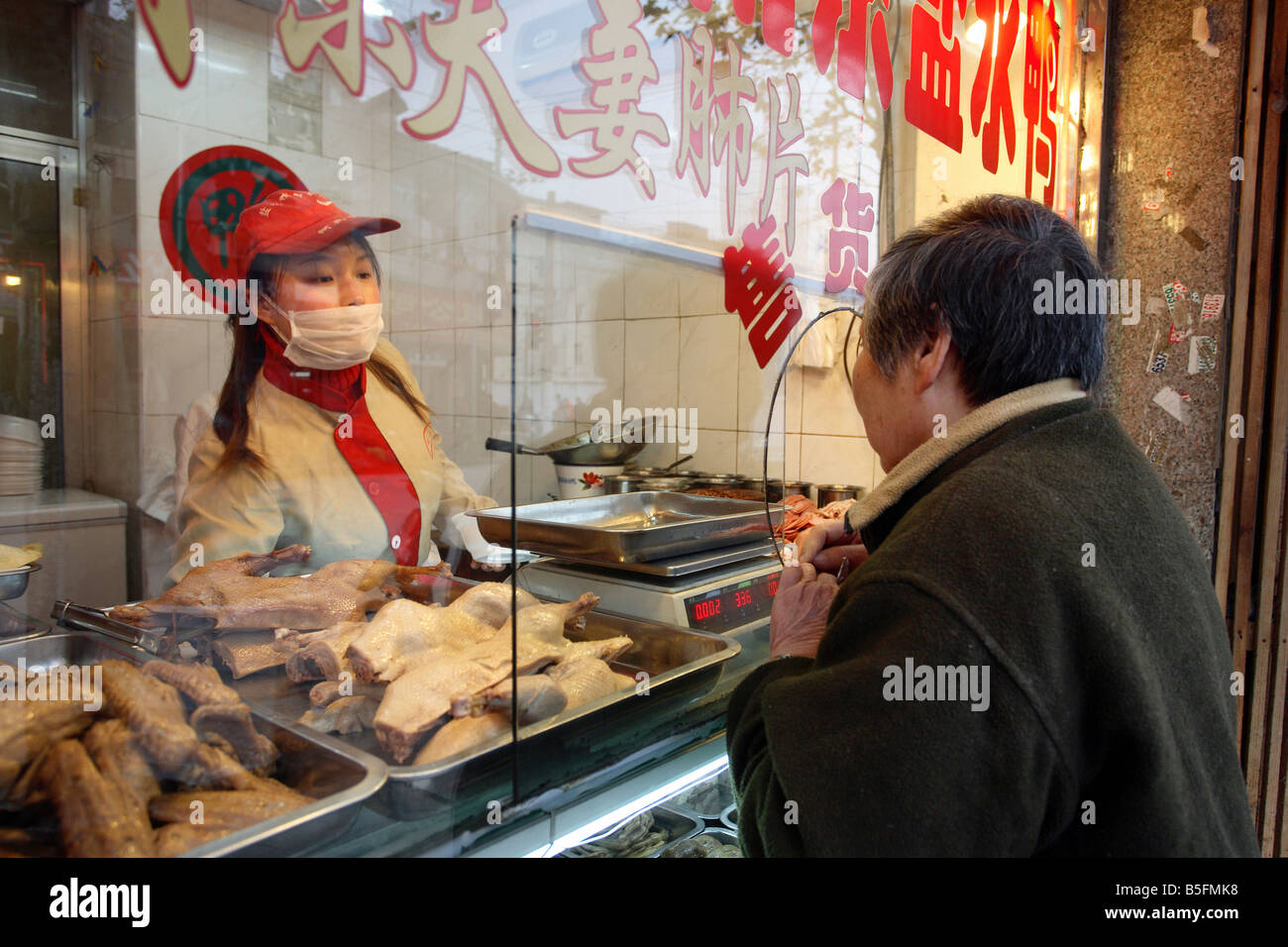 Woman buying poultry in a butcher shop in Shanghai, China Stock Photo ...