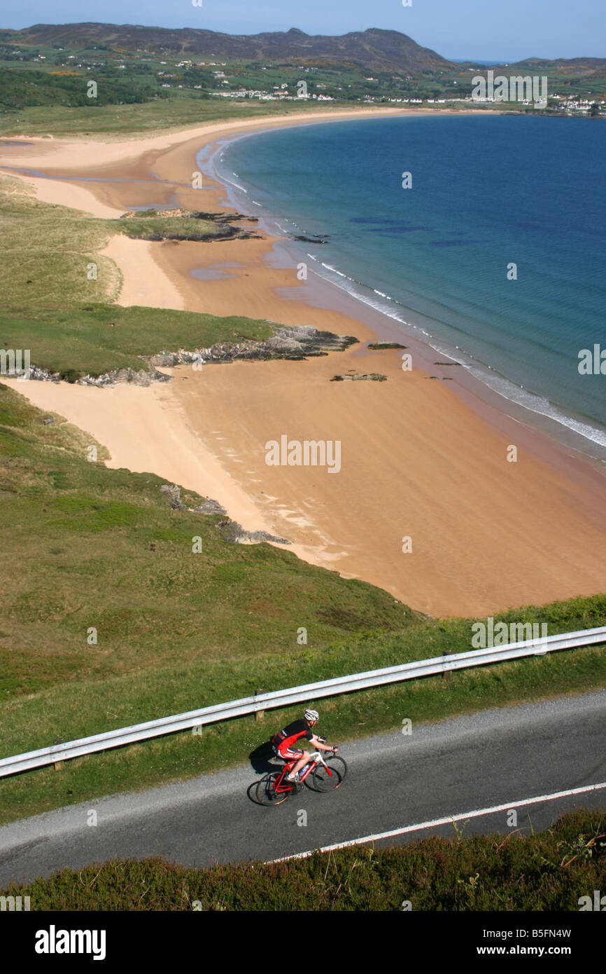 cyclist climbing the steep road up the Knockalla Mountains on the road ...