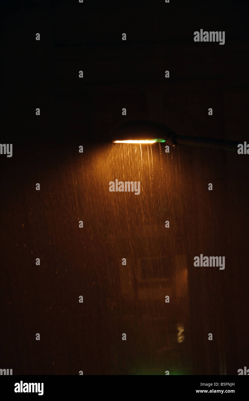 one street lamp in heavy rain at night city town Stock Photo - Alamy
