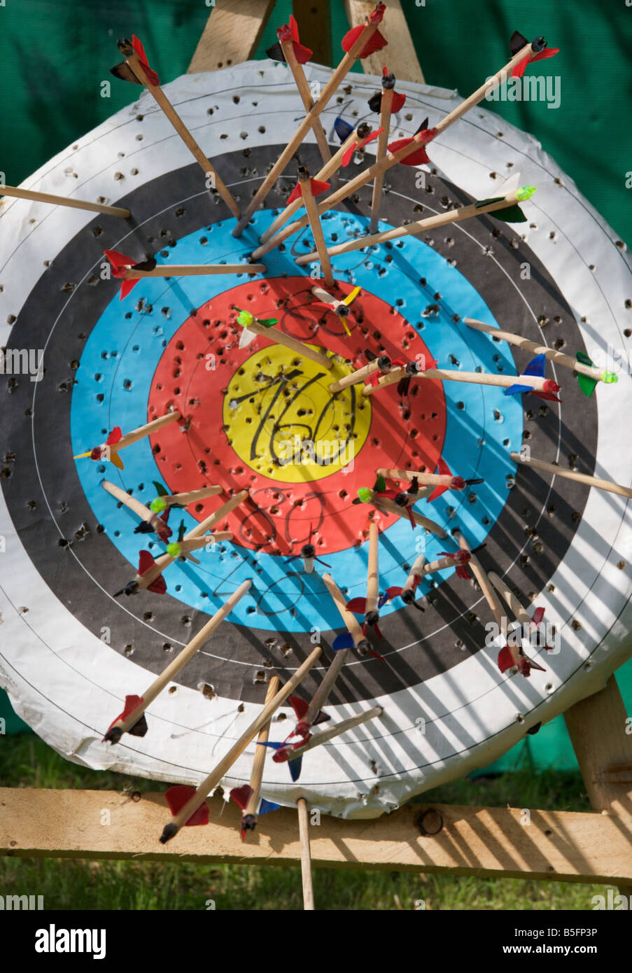 Closeup of several tens of arrows sticking in an archery target with ...
