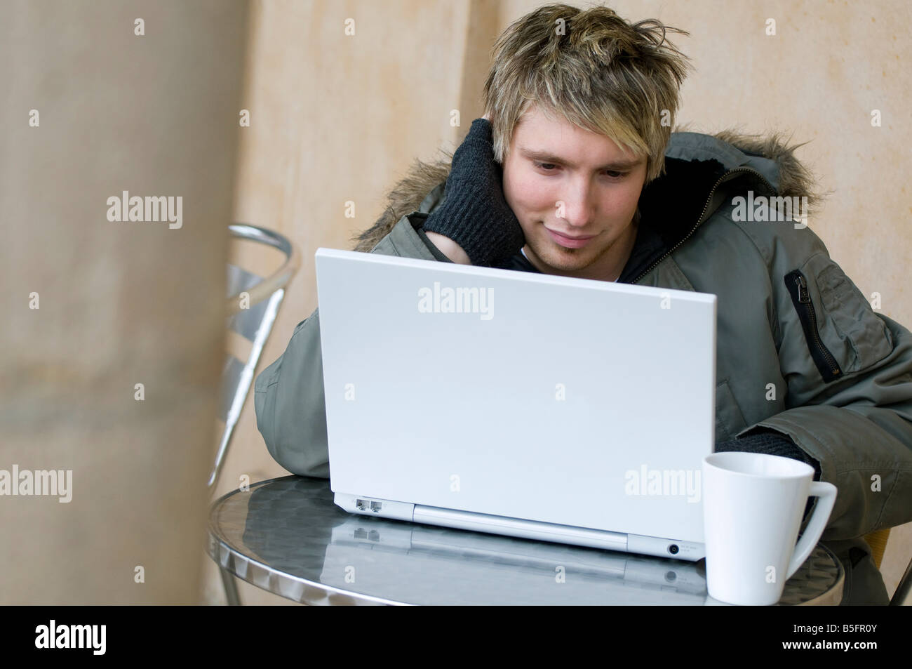 young male using laptop computer Stock Photo - Alamy