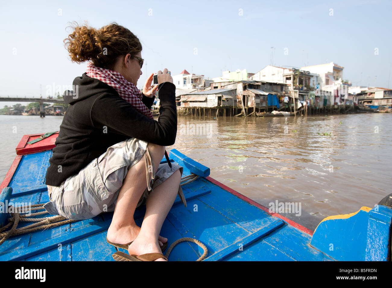 Young woman enjoying a boat trip in the MEkong Delta close to Vinh Long ...