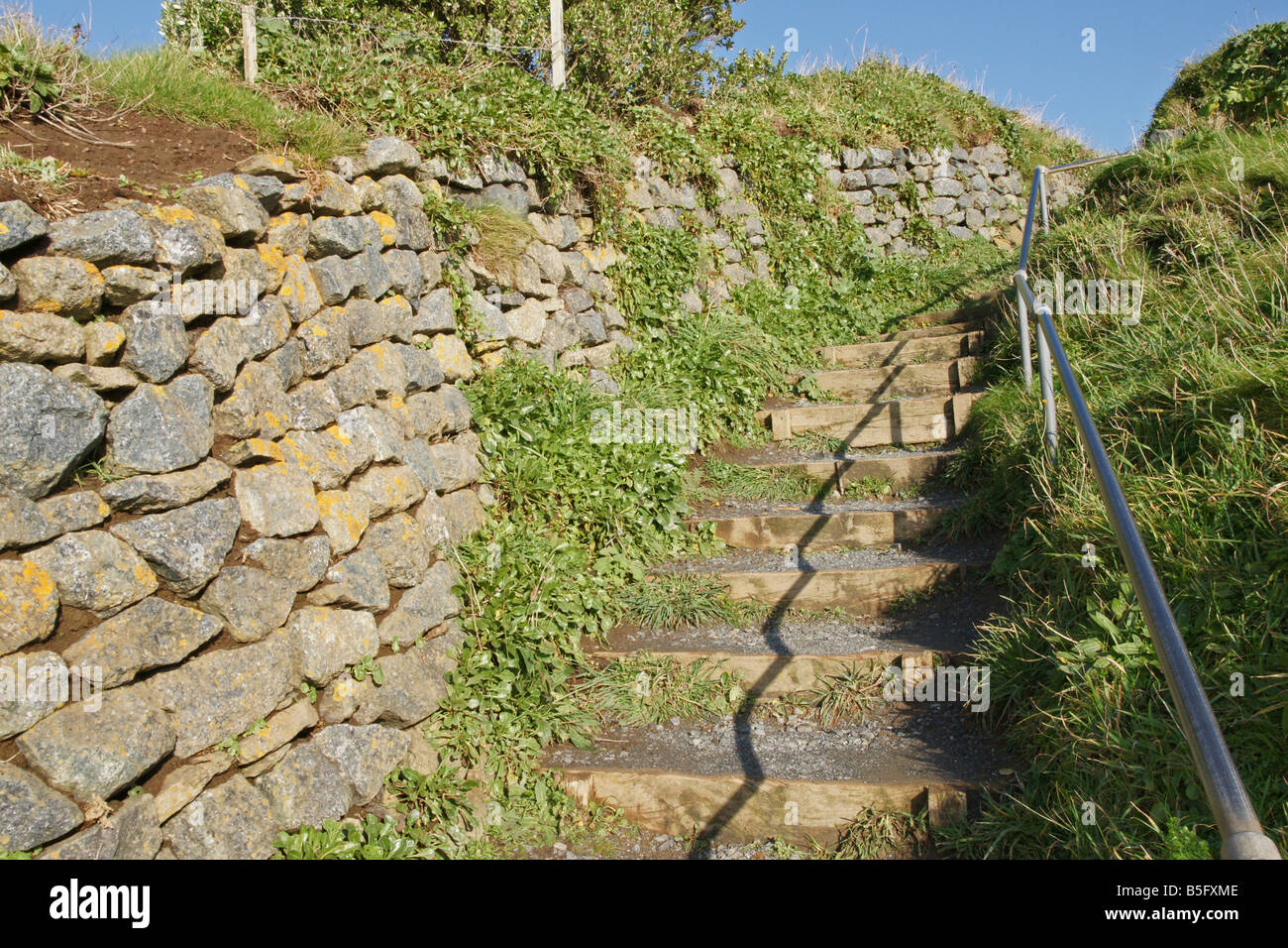Steep path with stone wall up from Lizard Point Cornwall England Stock ...