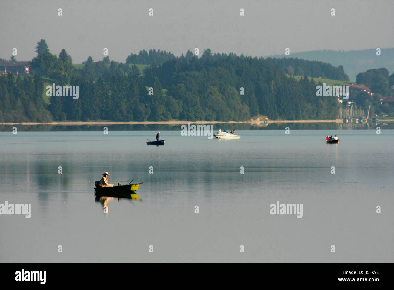 angler fishing on lake Forggensee near Fuessen Allgaeu Bavaria Germany ...