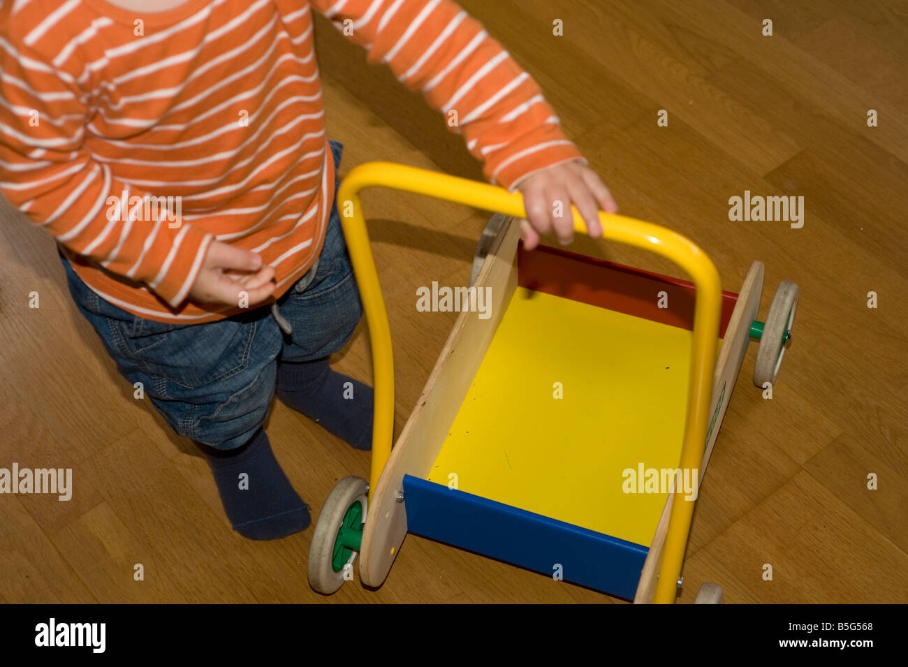 A young child learning to walk Stock Photo - Alamy