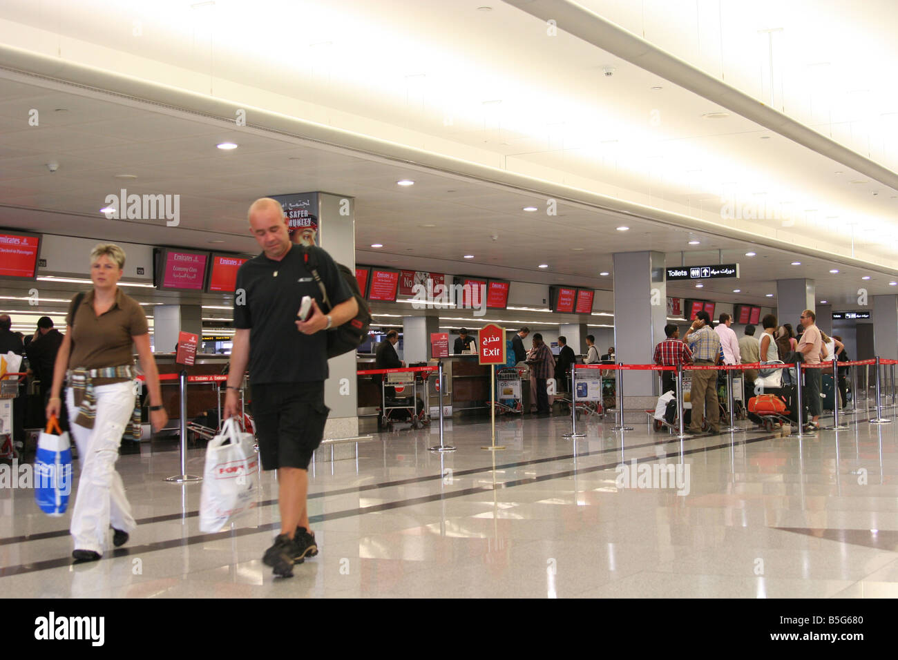 Passengers checking in at Dubai International Airport UAE Stock Photo ...