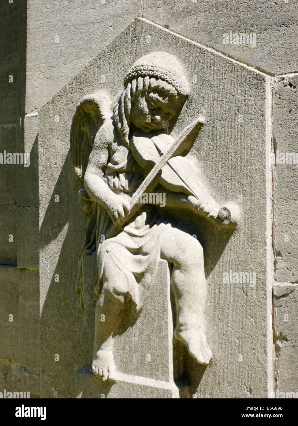 Cherub playing the violin detail of ancient tomb Stock Photo - Alamy