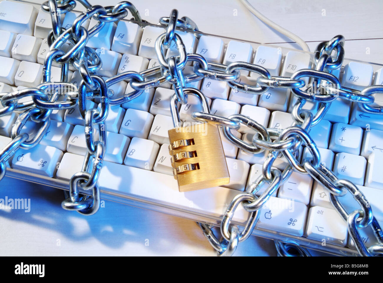 Chain around a computer keyboard Stock Photo - Alamy