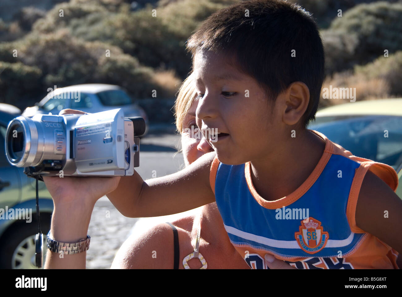 a child and his mother watching video camera Stock Photo - Alamy