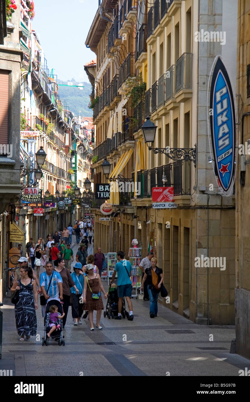 People shopping on a walking street in the city of Donostia San ...